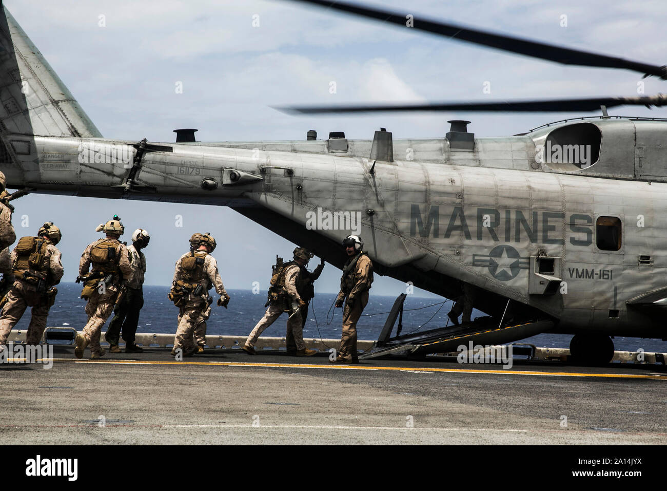 U.S. Marines load into a CH-53E Super Stallion aboard USS Essex Stock ...