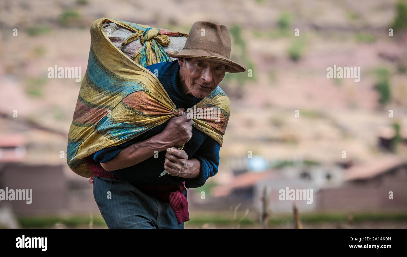 Man carrying heavy bag hi-res stock photography and images - Alamy