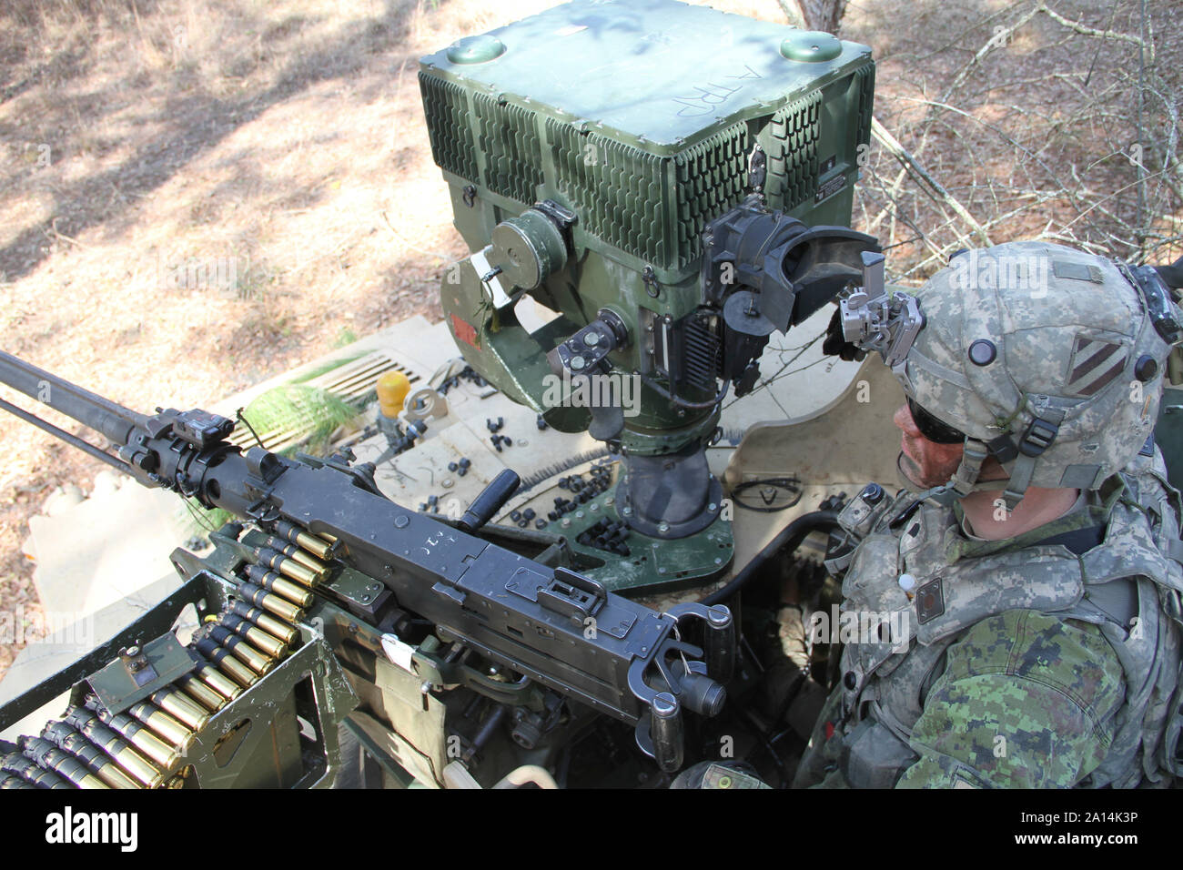 A U.S. Army cavalry scout observes for enemy movement while mounted on ...