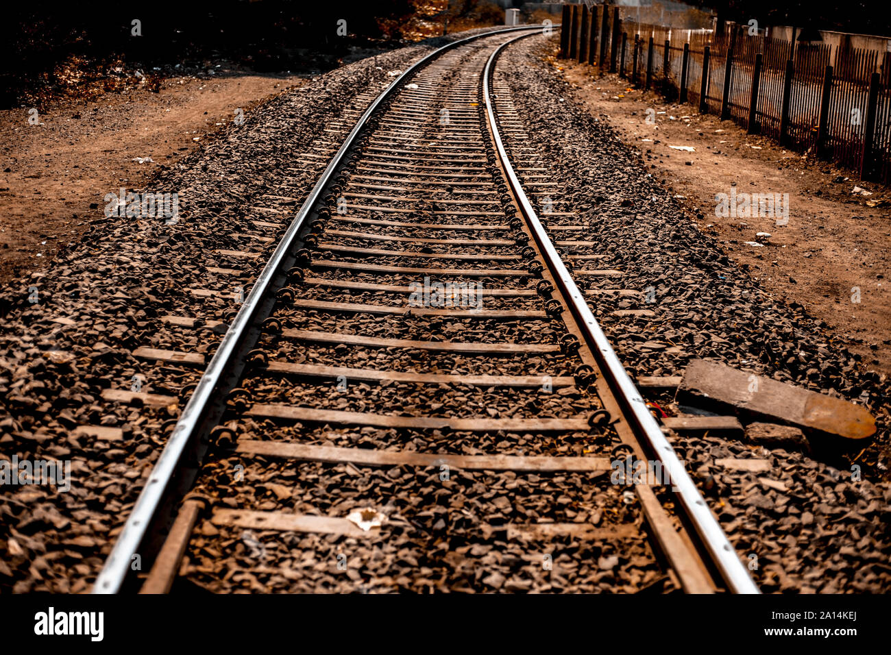 Close up of railway tracks passing or running straight through a forest ...