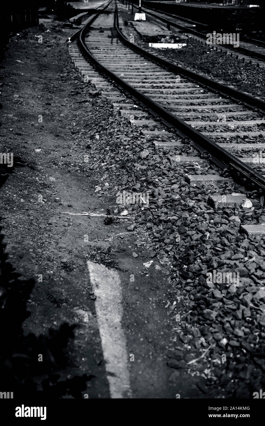 Empty railway track and freight train passing hi-res stock photography ...