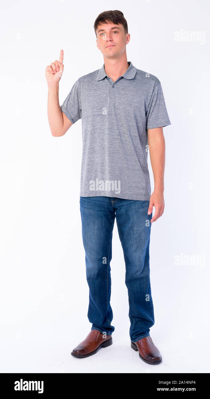 Full body shot of young handsome man pointing up Stock Photo - Alamy