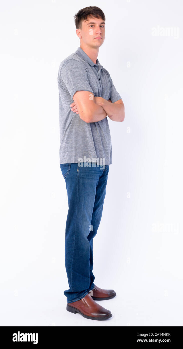 Full body shot profile view of young handsome man looking at camera ...