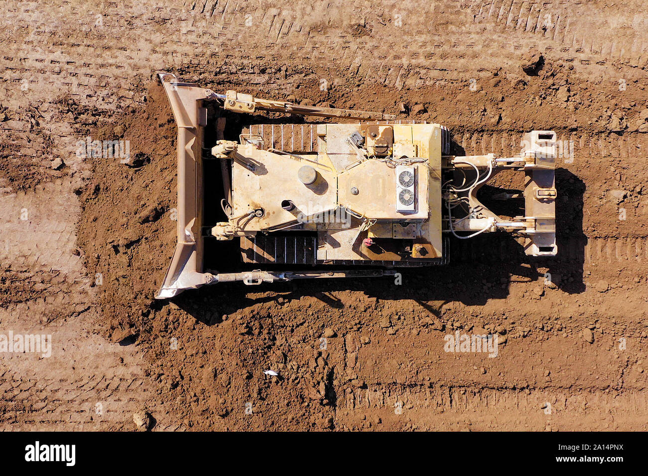 Bulldozer pushing large amount of fresh soil, Aerial image Stock Photo ...