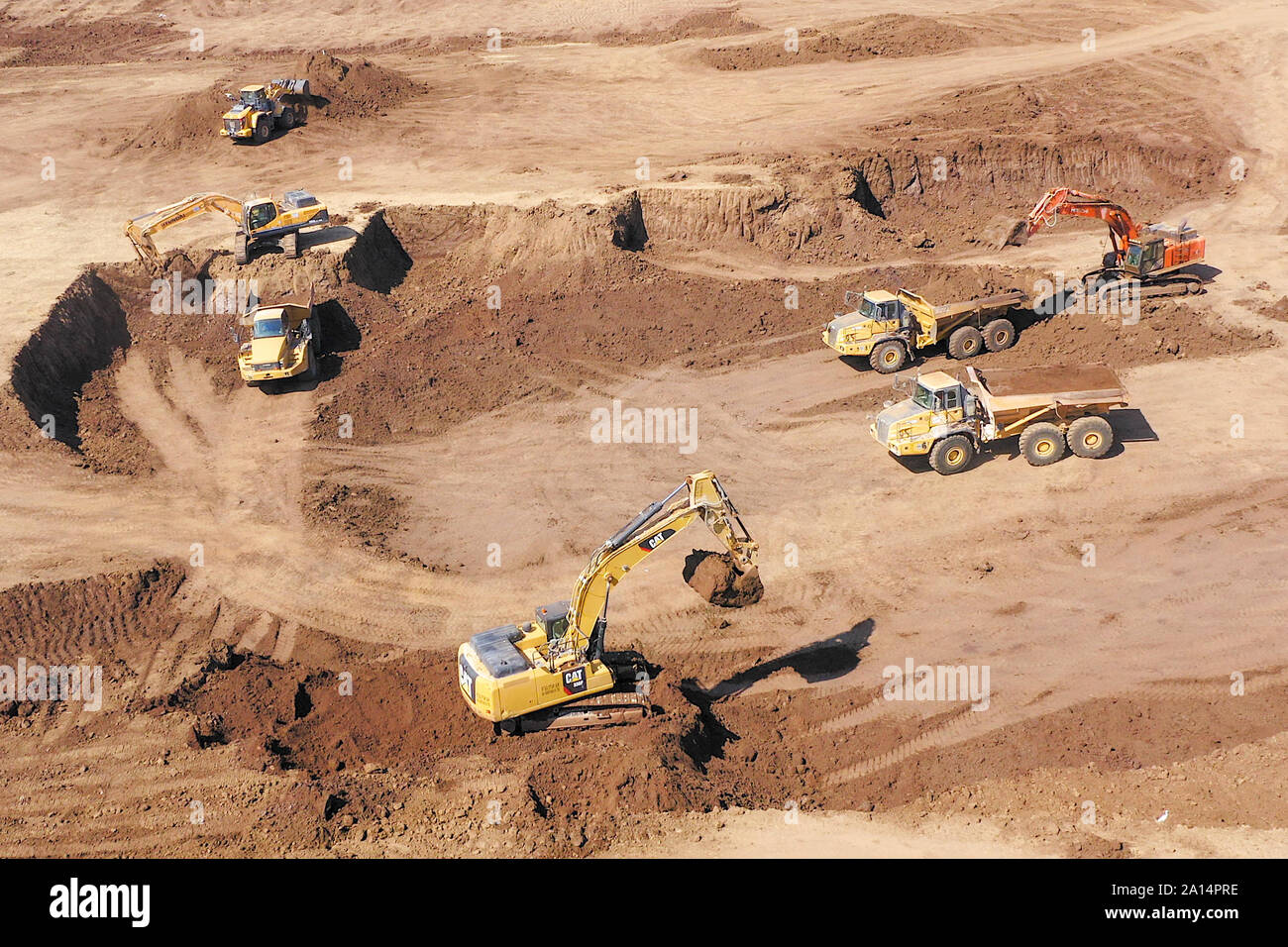 Excavators loading soil onto an Articulated hauler Trucks, Aerial image ...