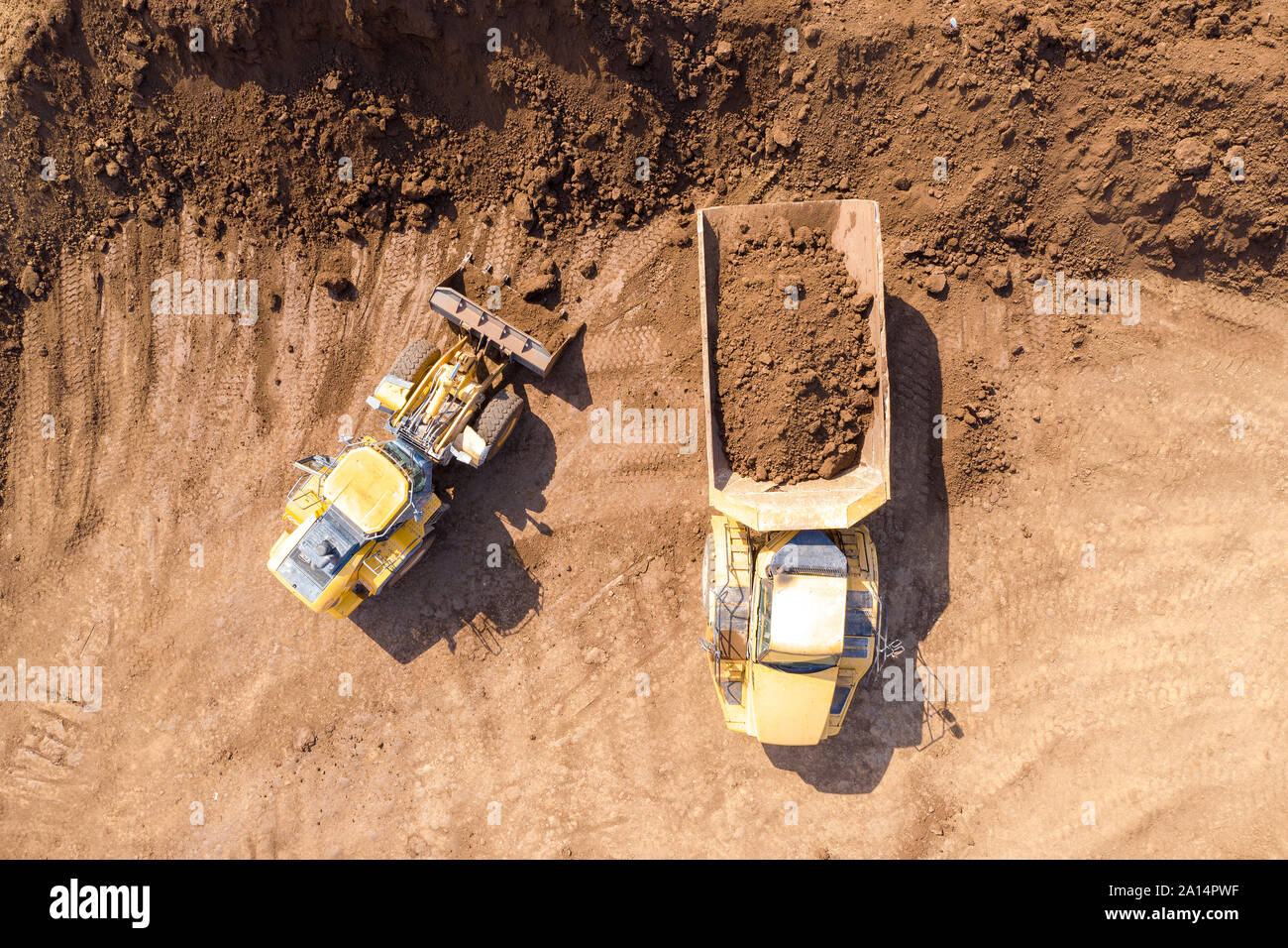 Excavator loading soil onto an Articulated hauler Truck, Top down ...