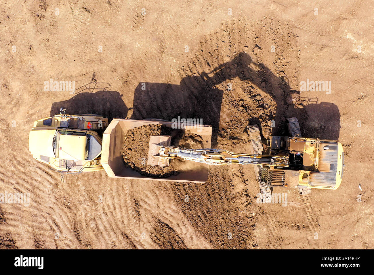 Excavator loading soil onto an Articulated hauler Truck, Top down ...