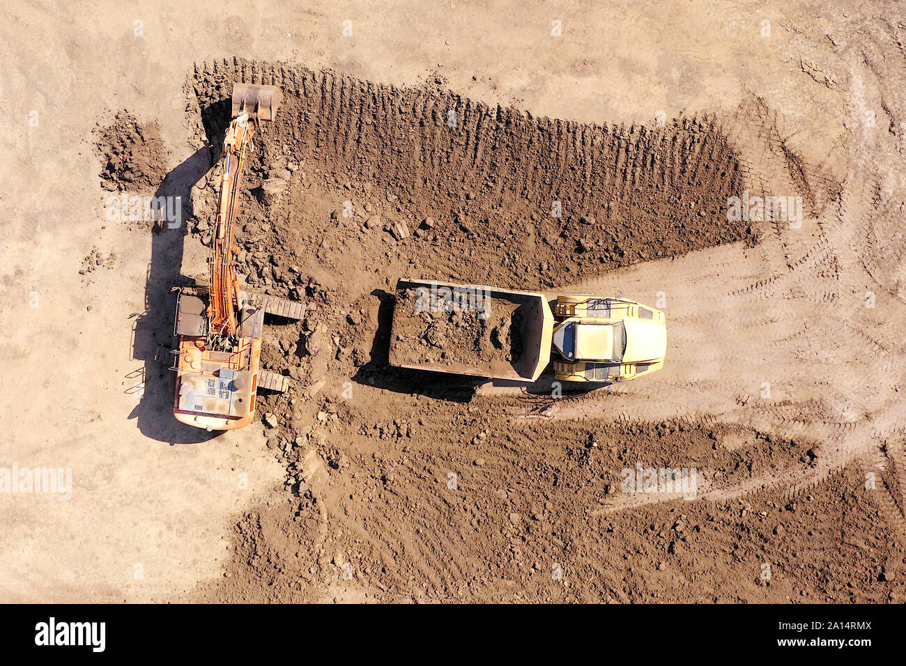 Excavator loading soil onto an Articulated hauler Truck, Top down ...