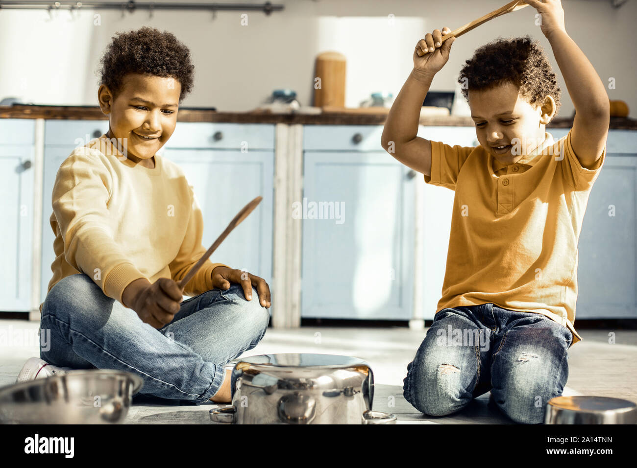 Brothers making a music studio out of the kitchen Stock Photo - Alamy