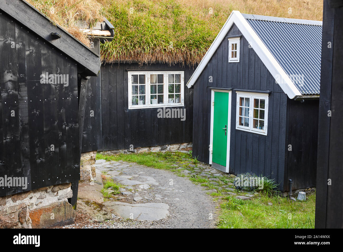 Traditional Faroe wooden black houses with grass turf roof. Picturesque ...