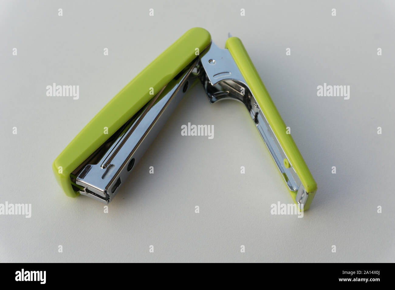 Green stapler isolated on white background Stock Photo - Alamy