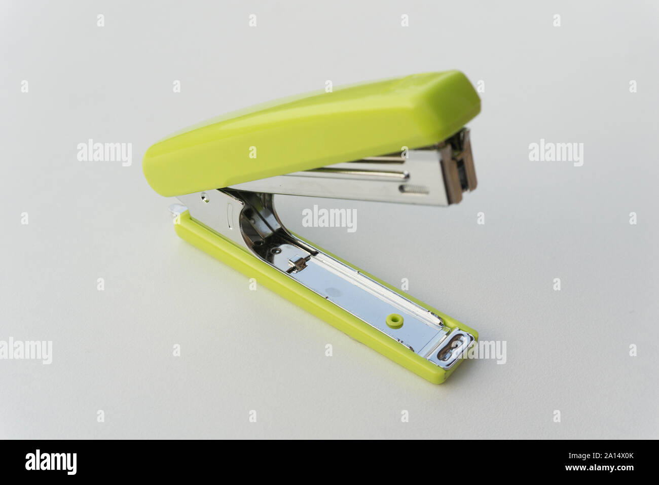 Green stapler isolated on white background Stock Photo - Alamy