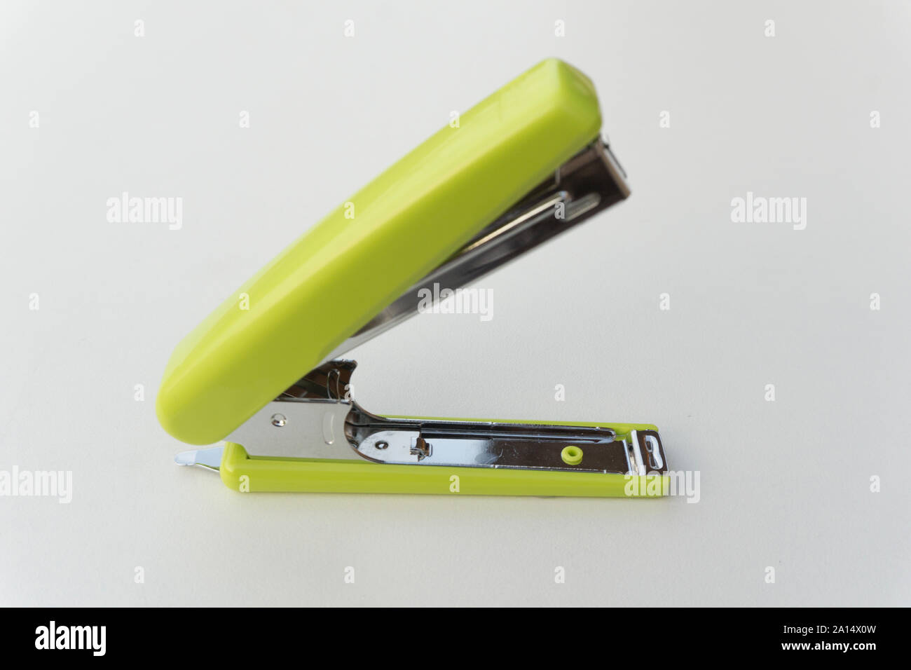Green stapler isolated on white background Stock Photo - Alamy