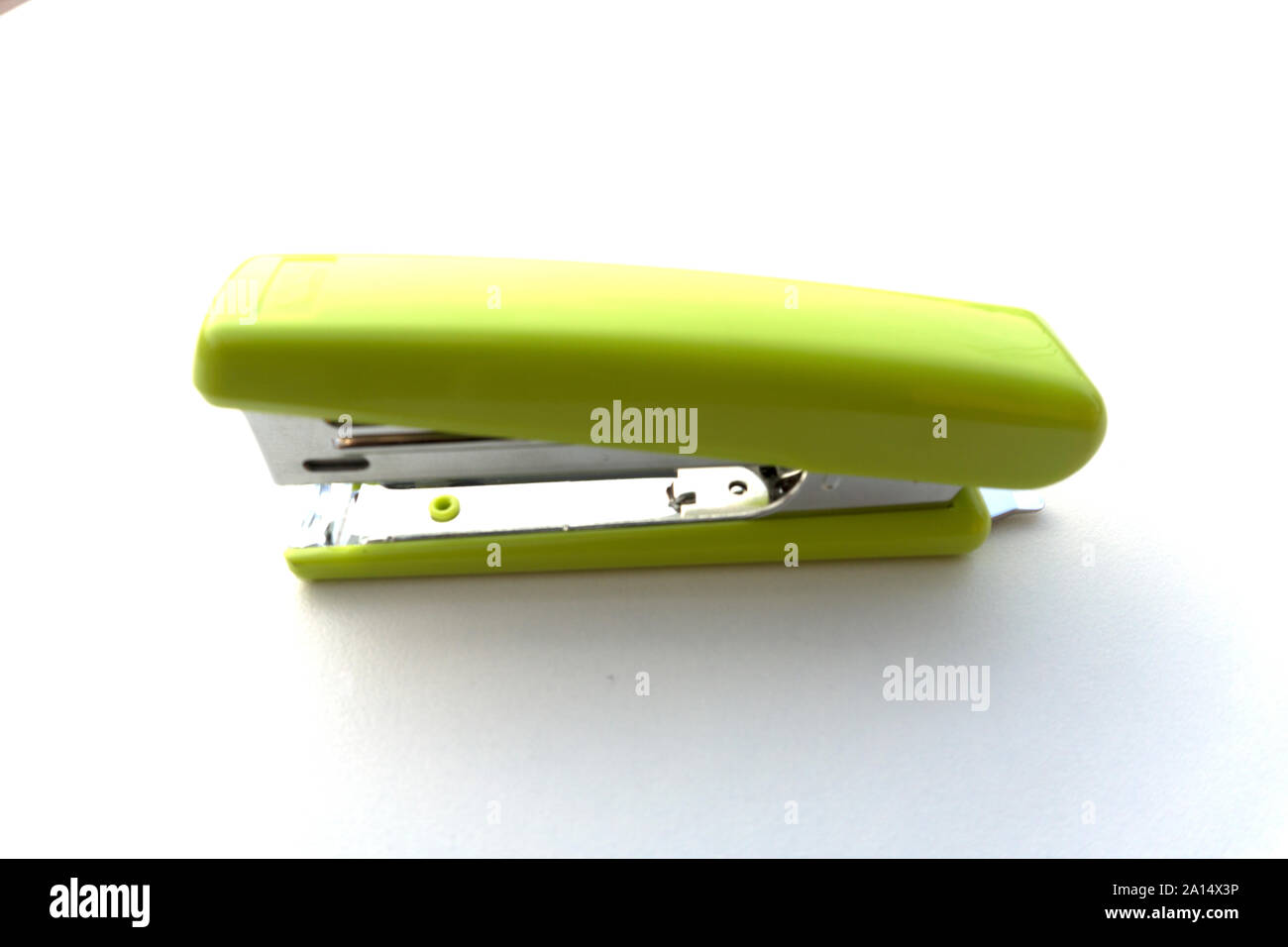 Green stapler isolated on white background Stock Photo - Alamy