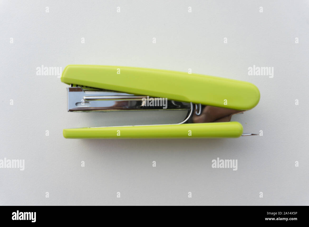 Green stapler isolated on white background Stock Photo - Alamy