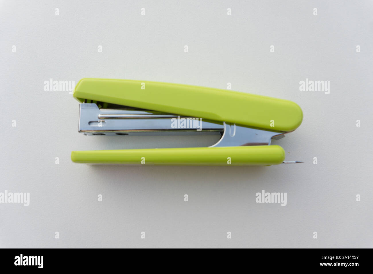 Green stapler isolated on white background Stock Photo - Alamy