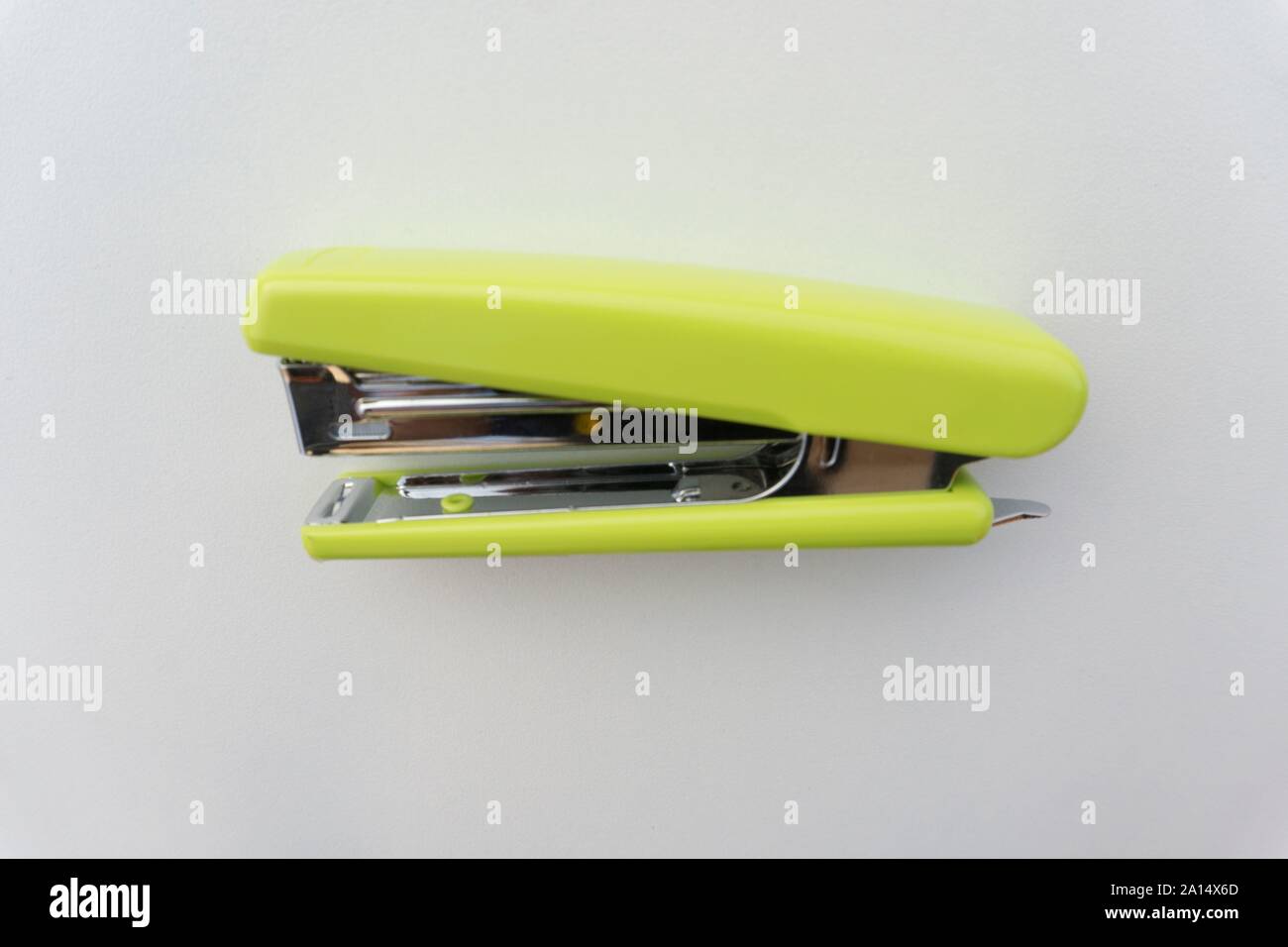 Green stapler isolated on white background Stock Photo - Alamy