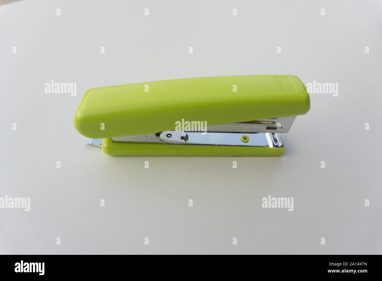 Green stapler isolated on white background Stock Photo - Alamy