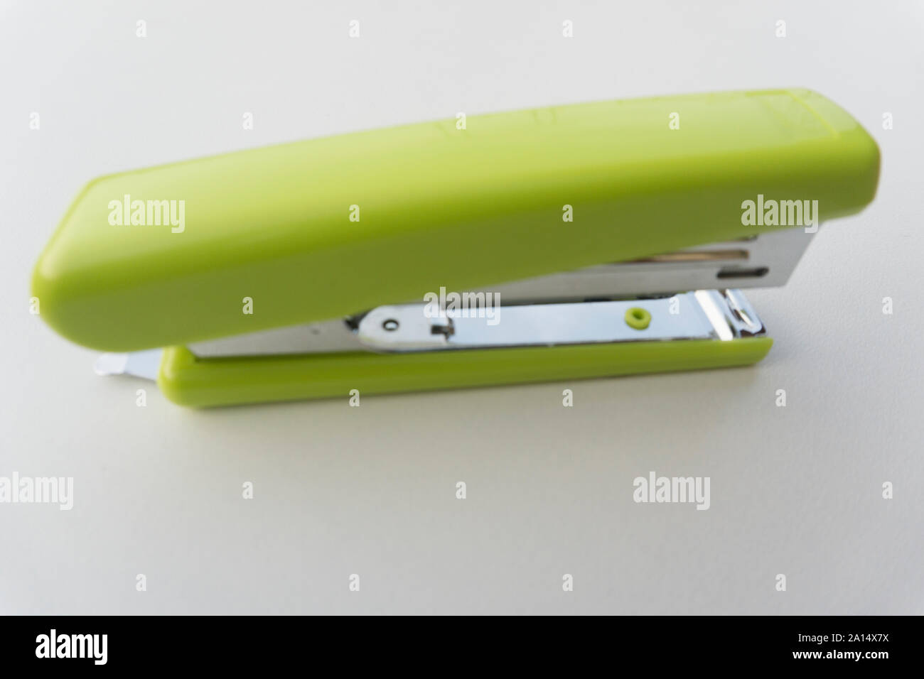 Green stapler isolated on white background Stock Photo - Alamy