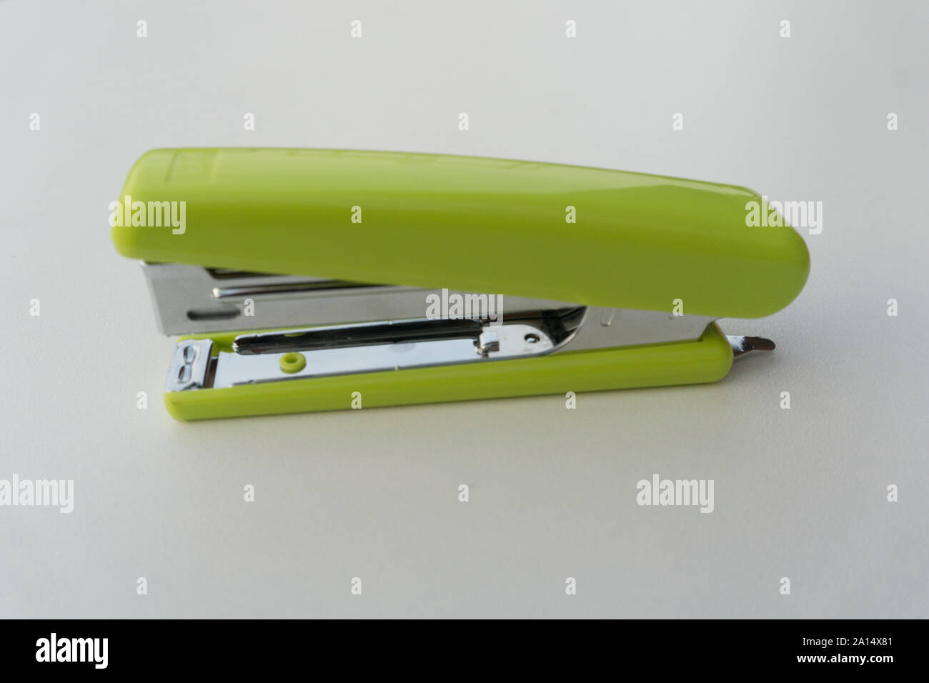 Green stapler isolated on white background Stock Photo - Alamy