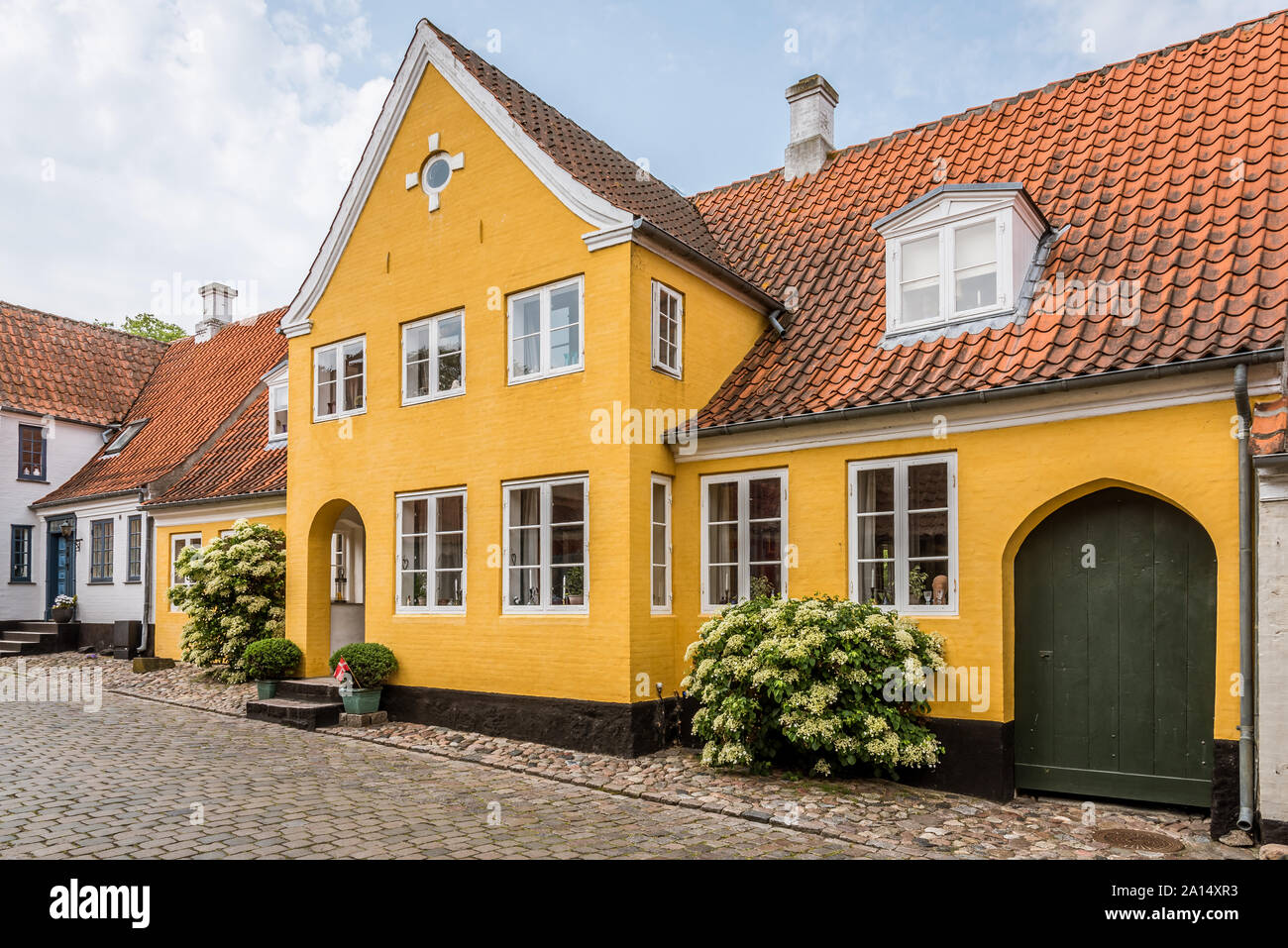 A beautiful yellow house in an old cobblestone street, Ærøskøbing ...