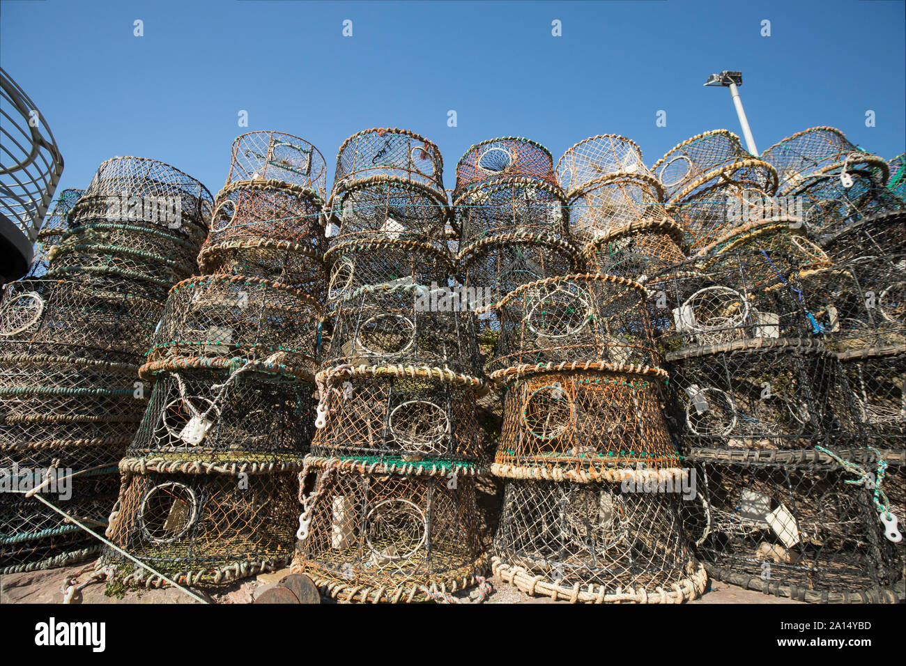 Cuttlefish pots stacked on the quayside at Brixham Harbour. Devon ...