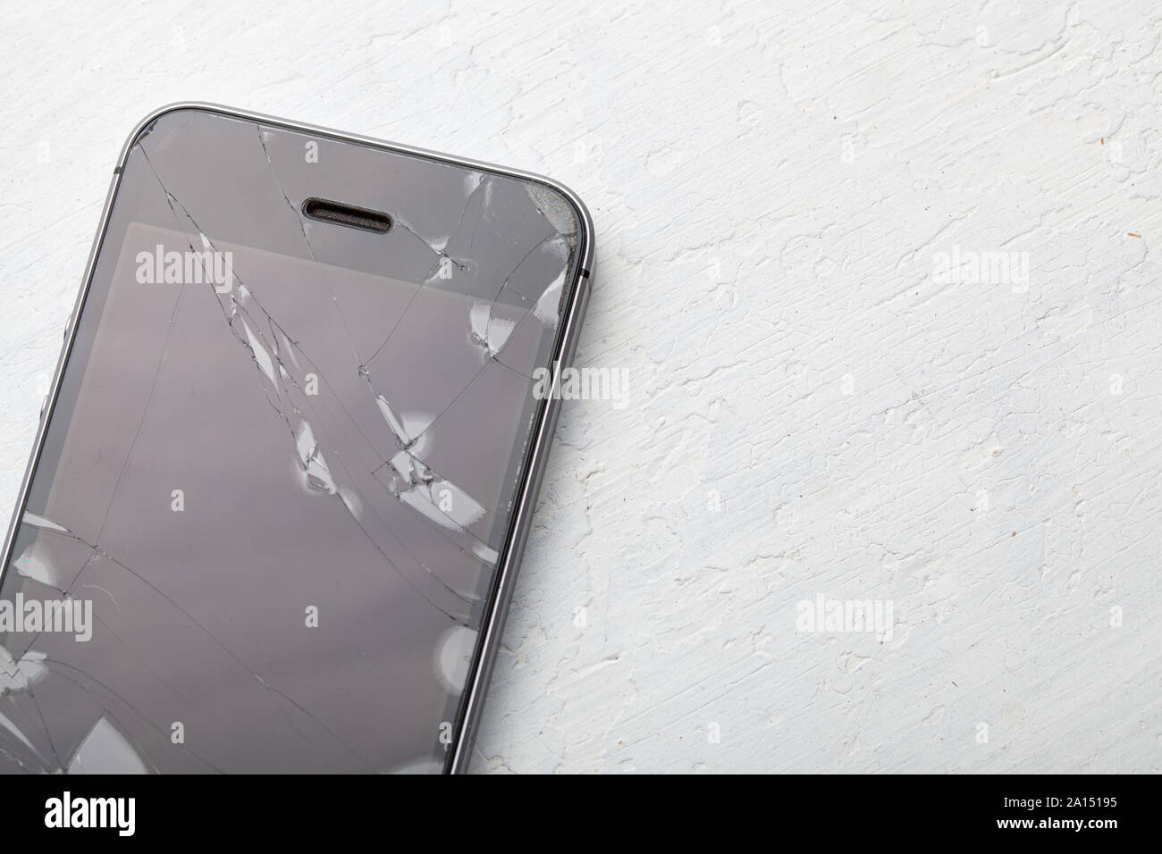 Broken glass phone. Cracks on the display of a mobile phone. Copy space ...