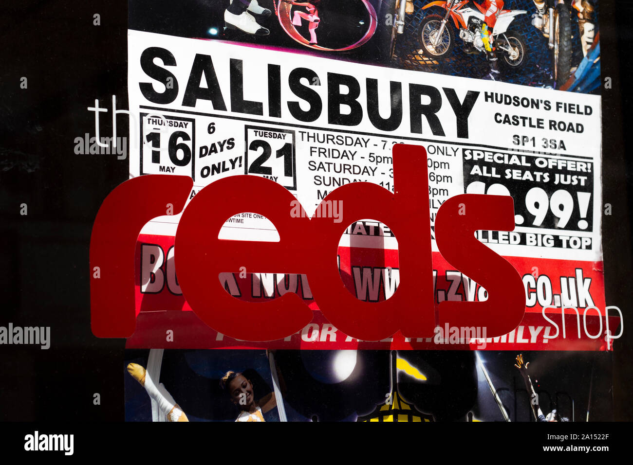 The Reds shop sign in office window with circus poster in background ...