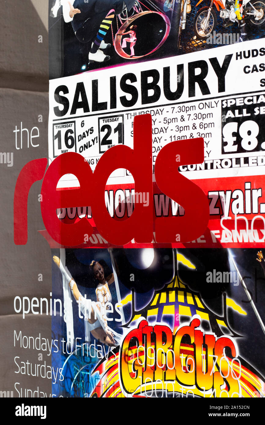 The Reds shop sign in office window with circus poster in background ...
