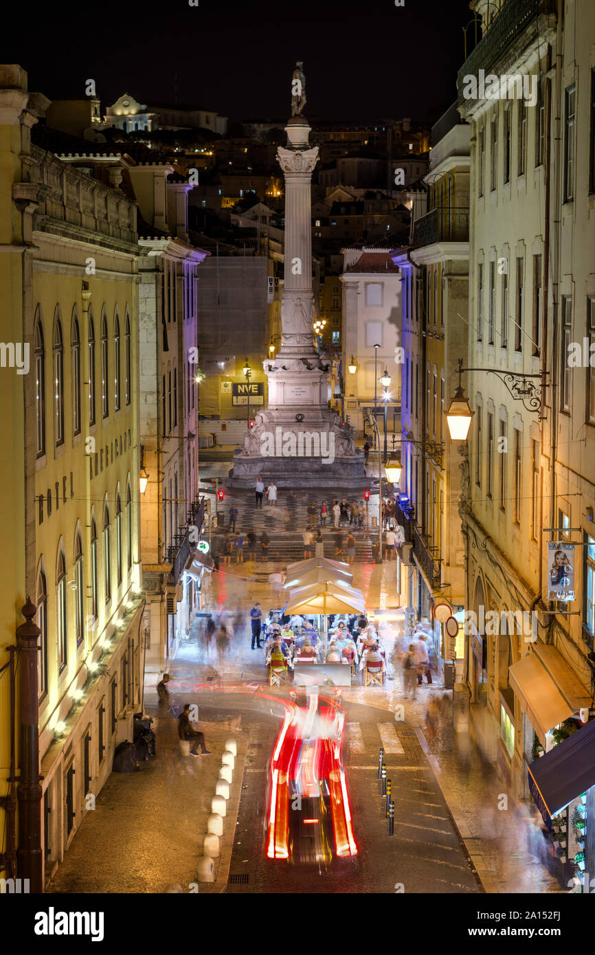 Traffic, people and al fresco dining on Calcada do Carmo street and ...