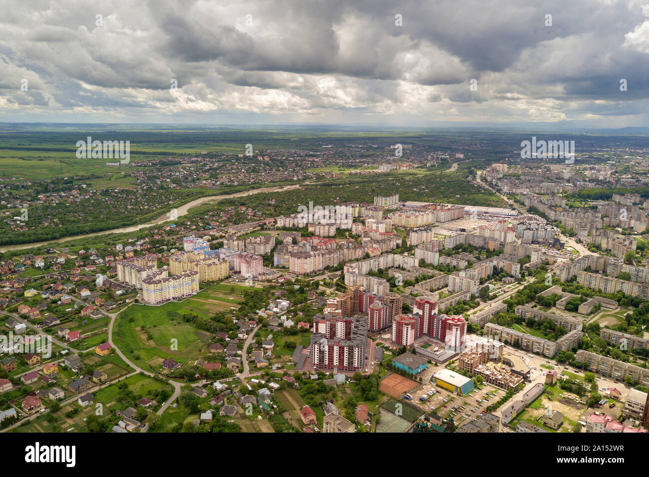 Aerial view of town or city with rows of buildings and curvy streets in ...