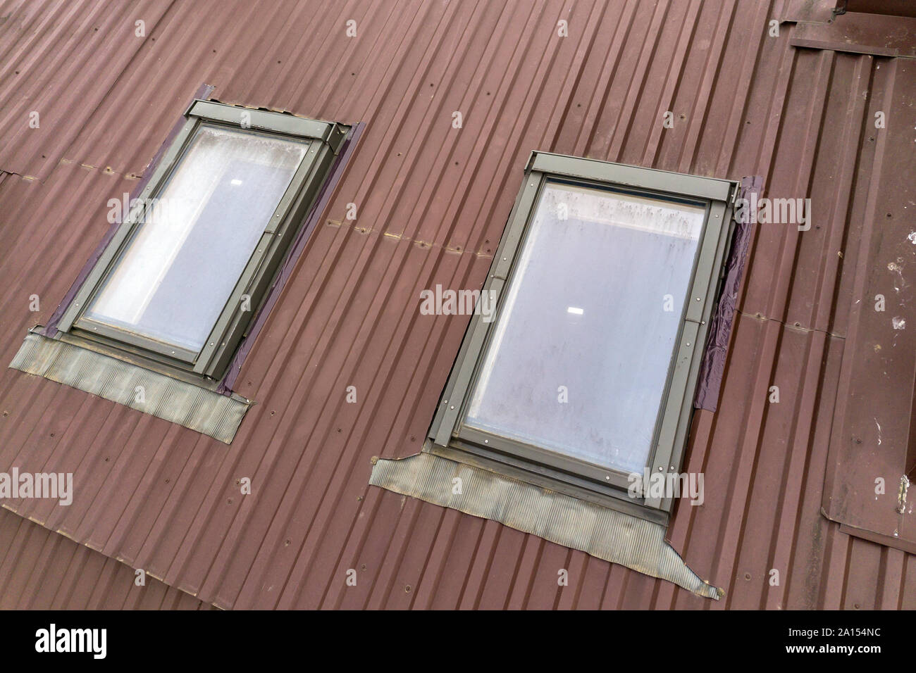 Roof of a house made from metal sheets with attic windows Stock Photo ...