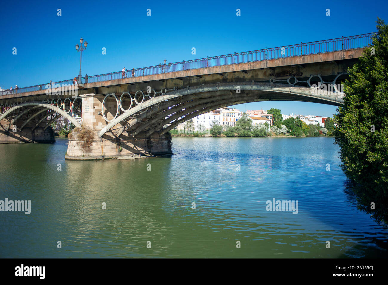 Seville river, view of the Punte de Isabel II (Triana) bridge spanning ...