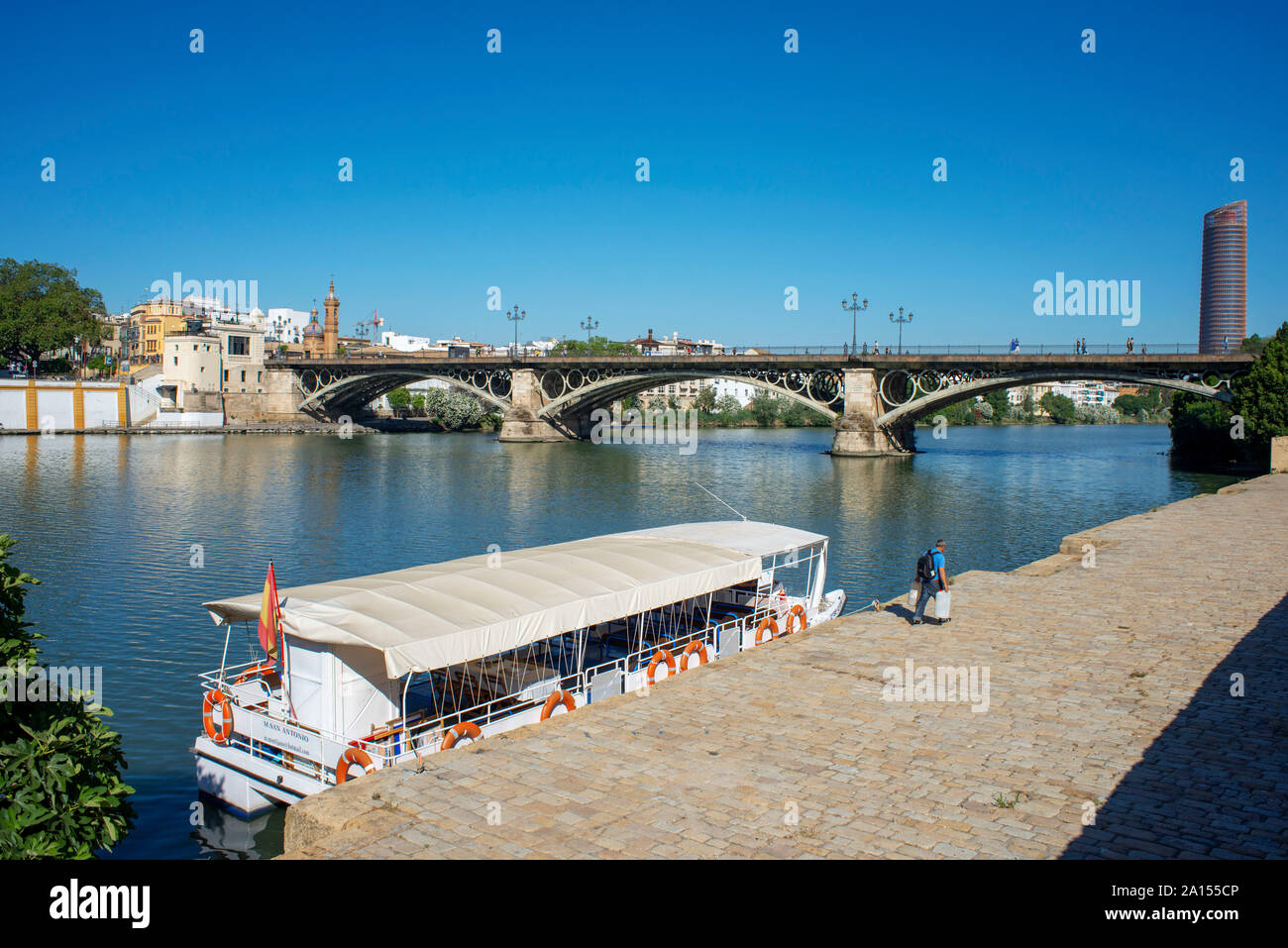 Seville river, view of the Punte de Isabel II (Triana) bridge spanning ...