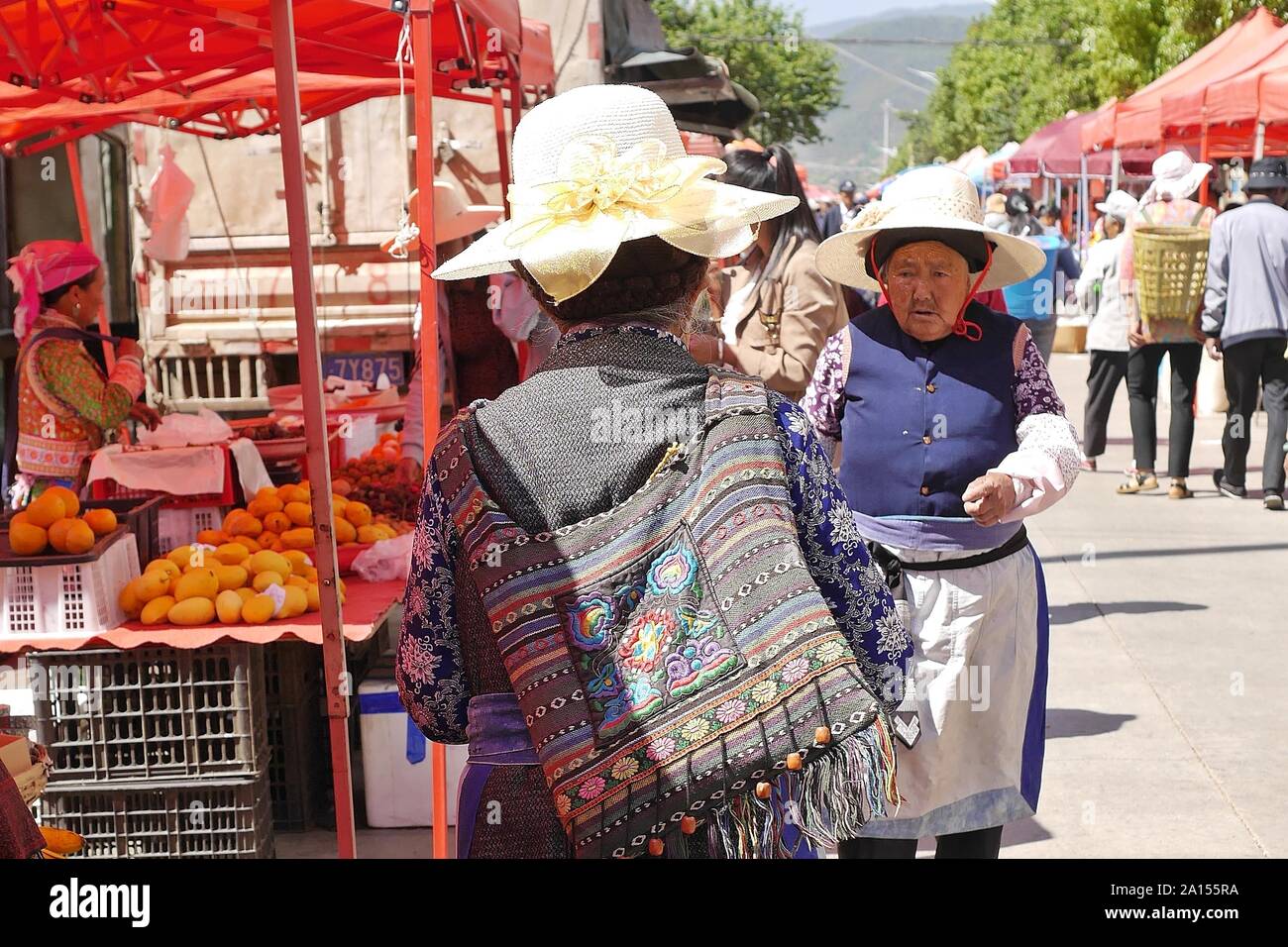 Local ethnic groups of people sell and buy products at Friday flea ...