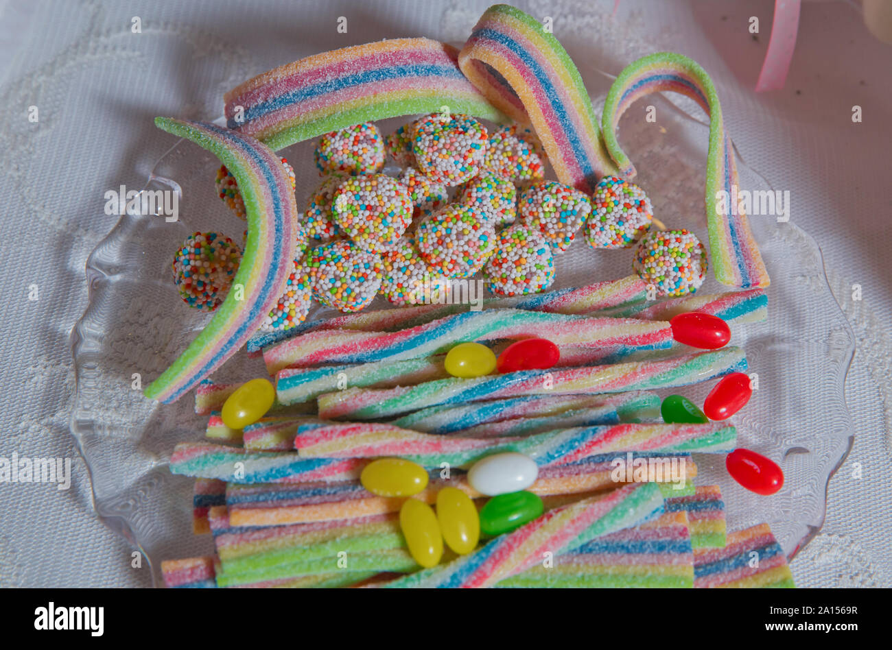 Sour rainbow Confectionery strips. Colorful gummy candies pattern on a ...
