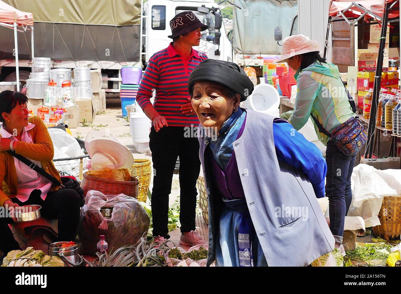 Local ethnic groups of people sell and buy products at Friday flea ...