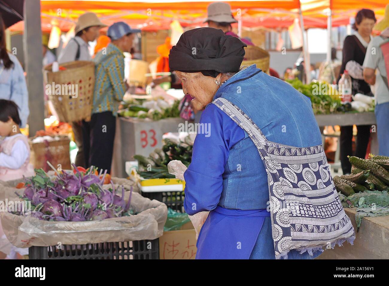 Local ethnic groups of people sell and buy products at Friday flea ...