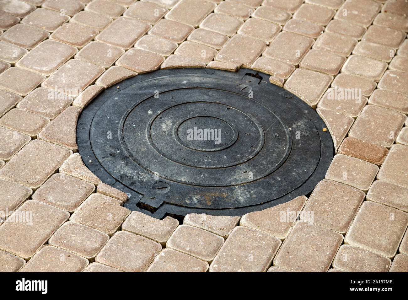 Old rusted metal gutter for rain water on the stone paved sidewalk ...