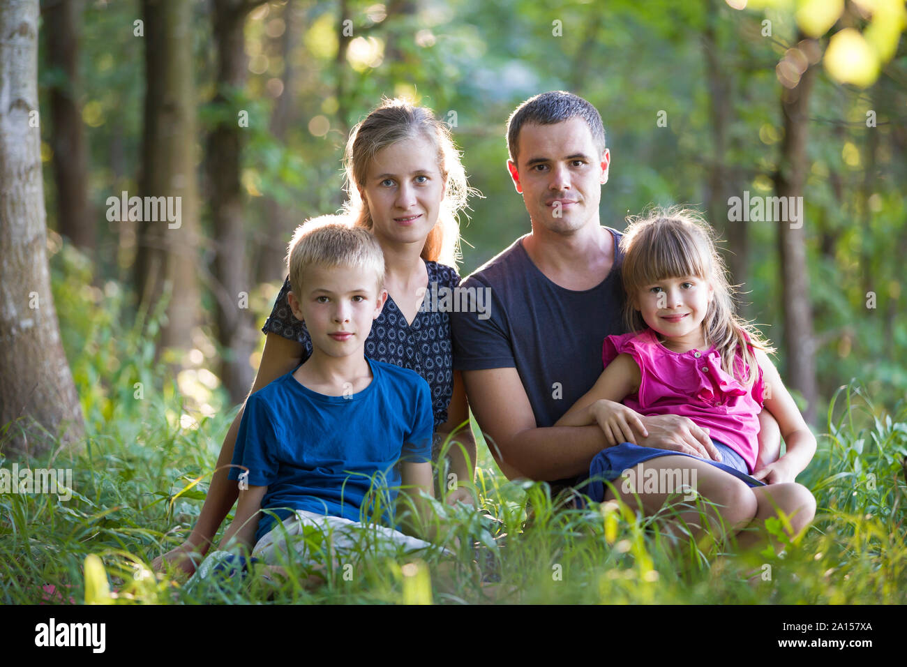 Family outdoors in forest. Portrait of young father, mother, daughter ...