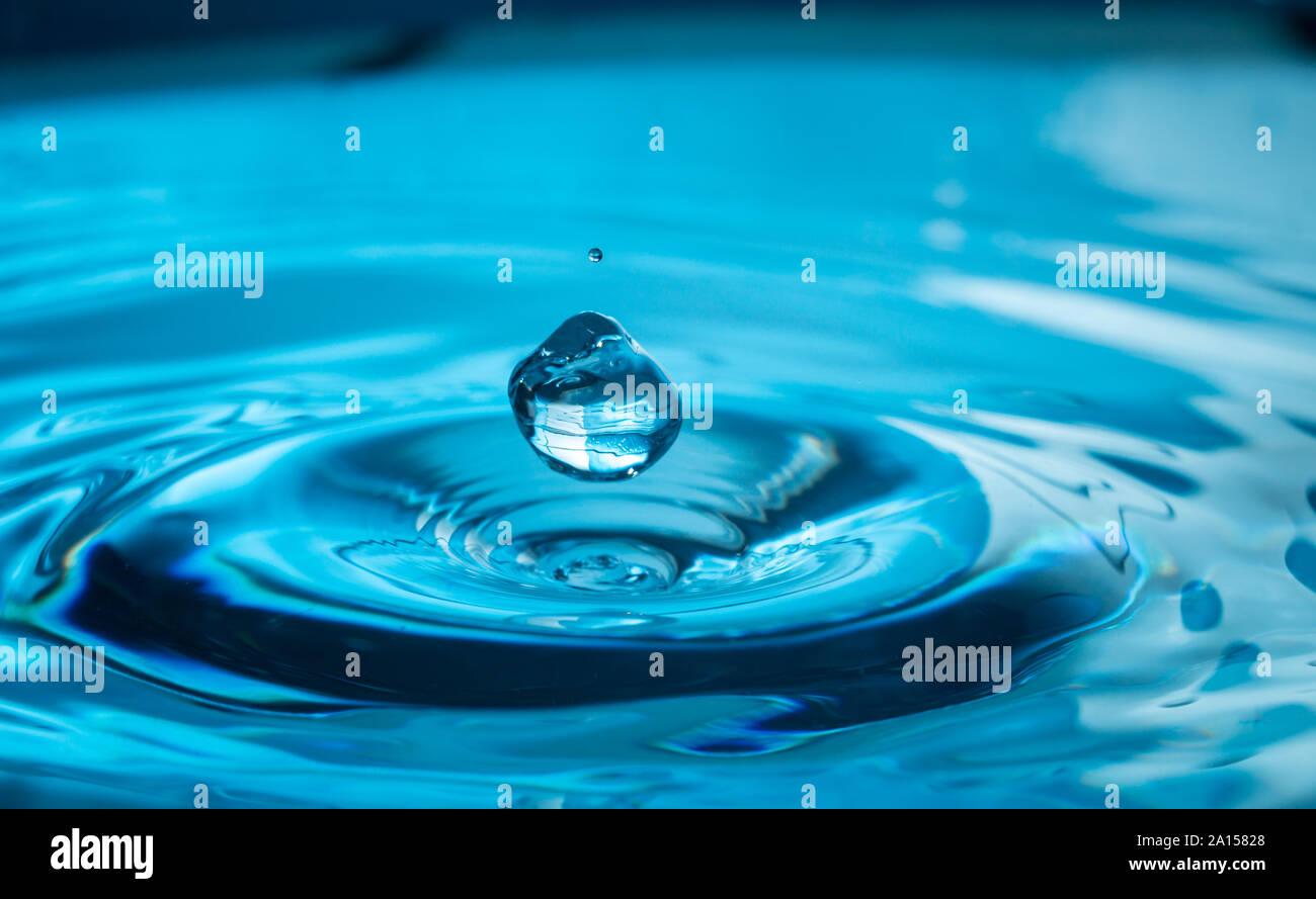 close up of a water drop impacting a body of water and splashing Stock ...