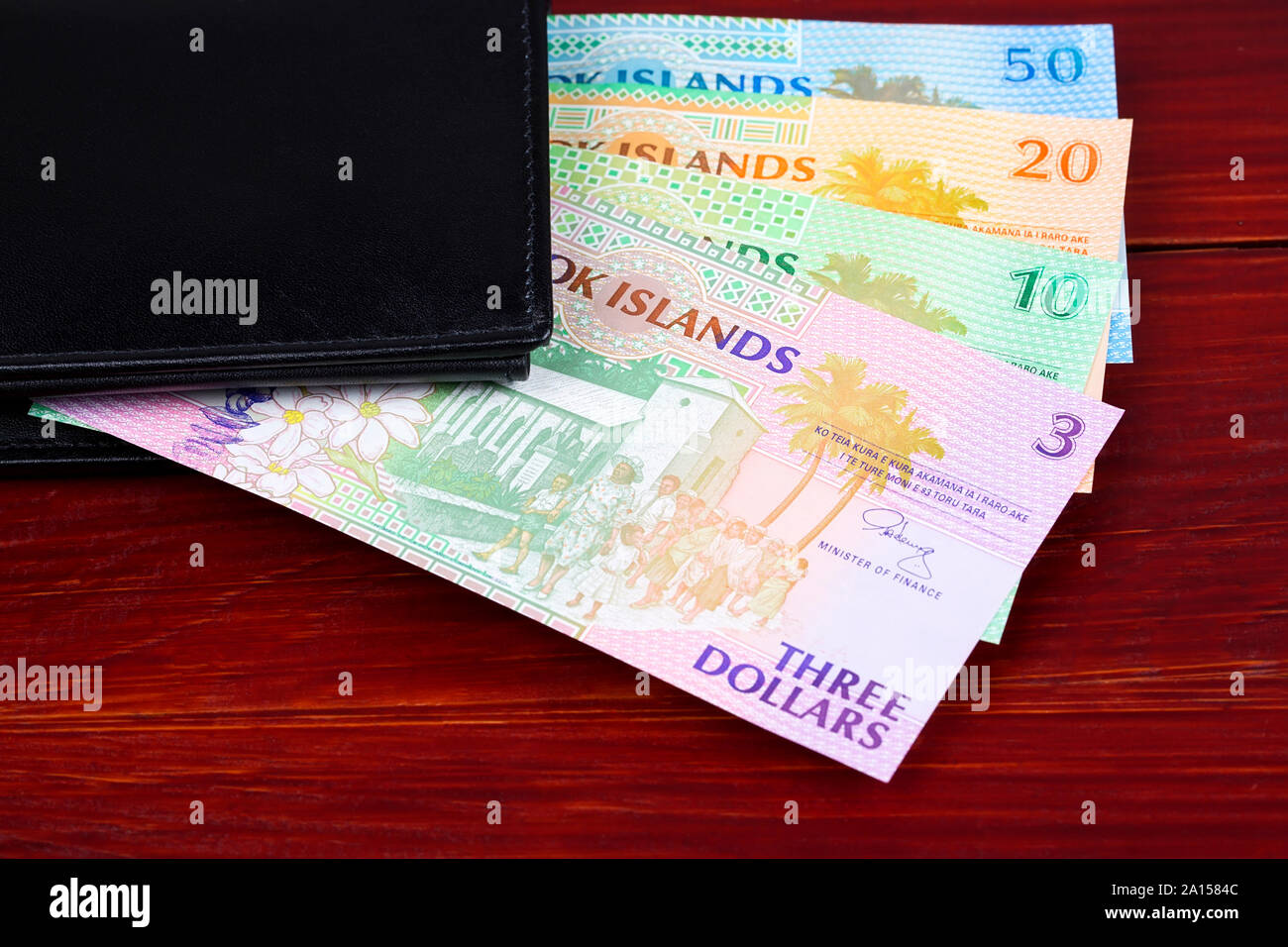 Money from Cook Islands in the black wallet Stock Photo - Alamy