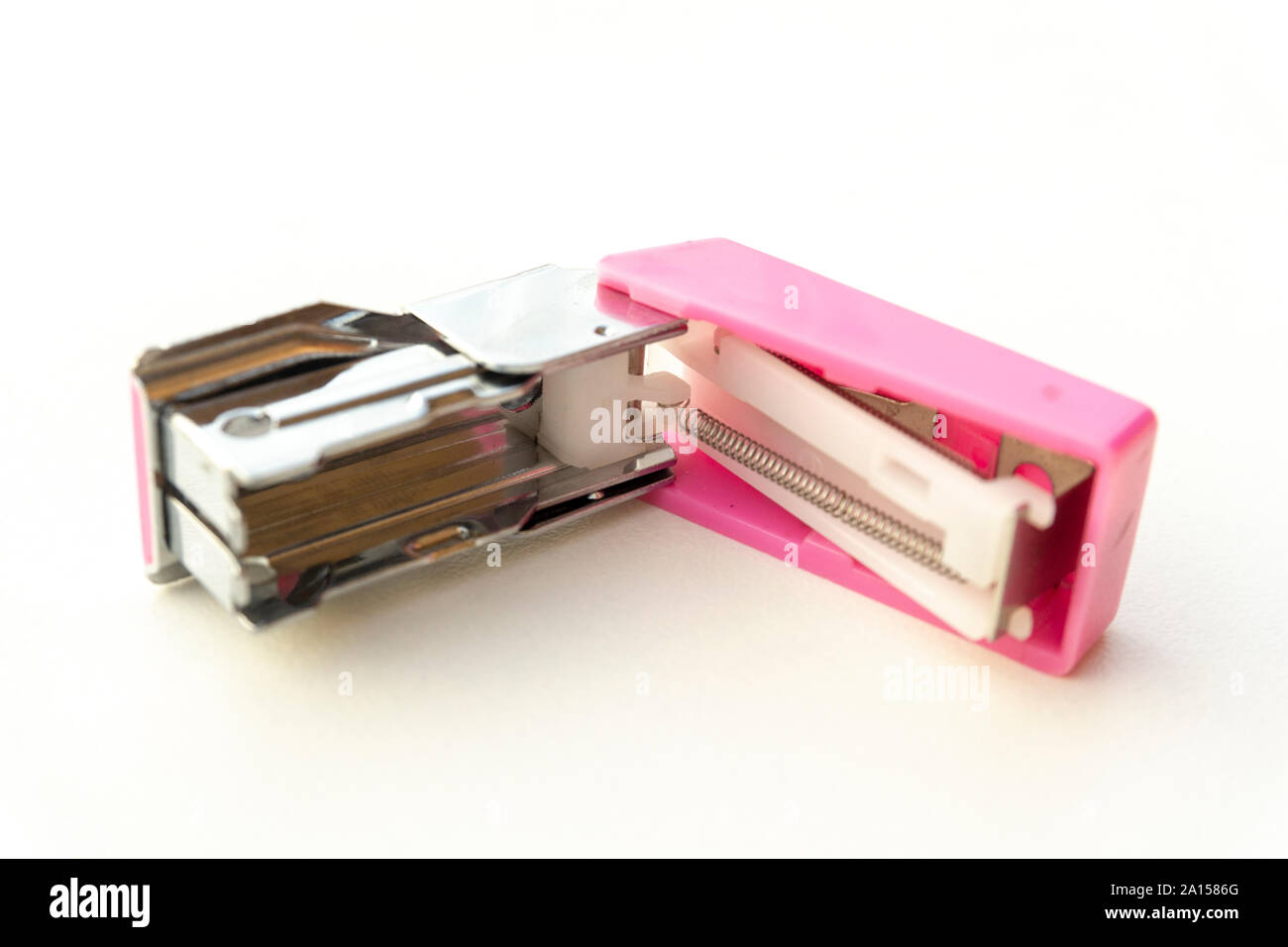 Small pink stapler isolated on white background Stock Photo - Alamy