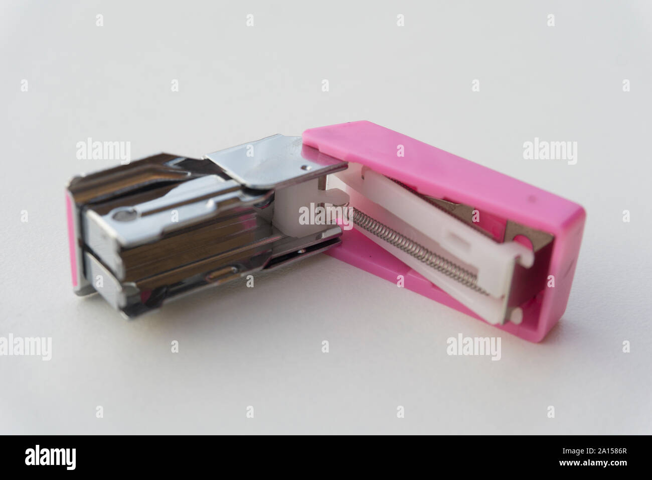 Small pink stapler isolated on white background Stock Photo - Alamy