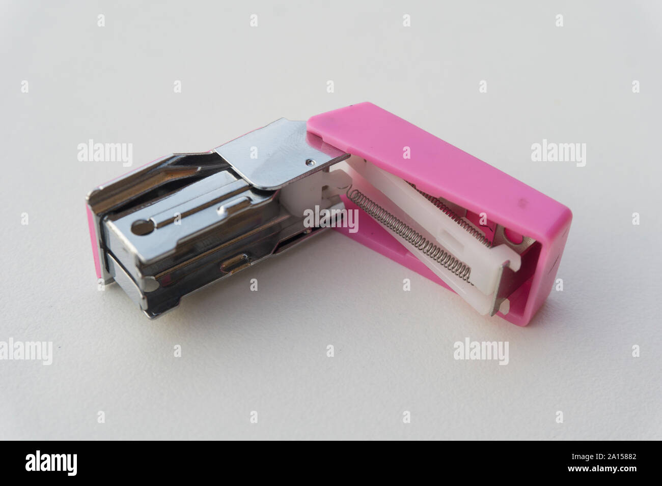 Small pink stapler isolated on white background Stock Photo - Alamy