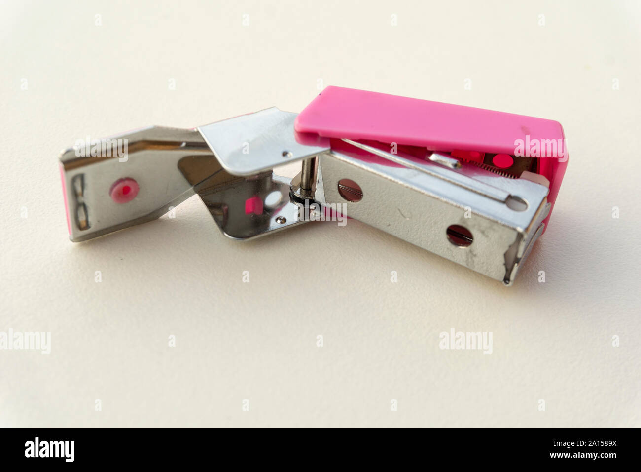 Small pink stapler isolated on white background Stock Photo - Alamy