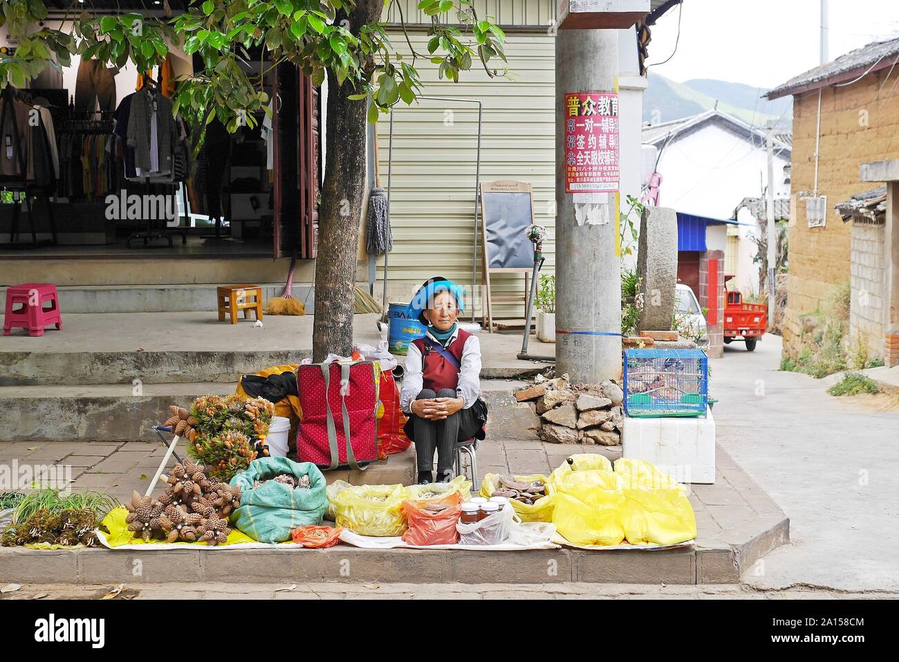 Local female Chinese ethnic people selling traditional products at ...