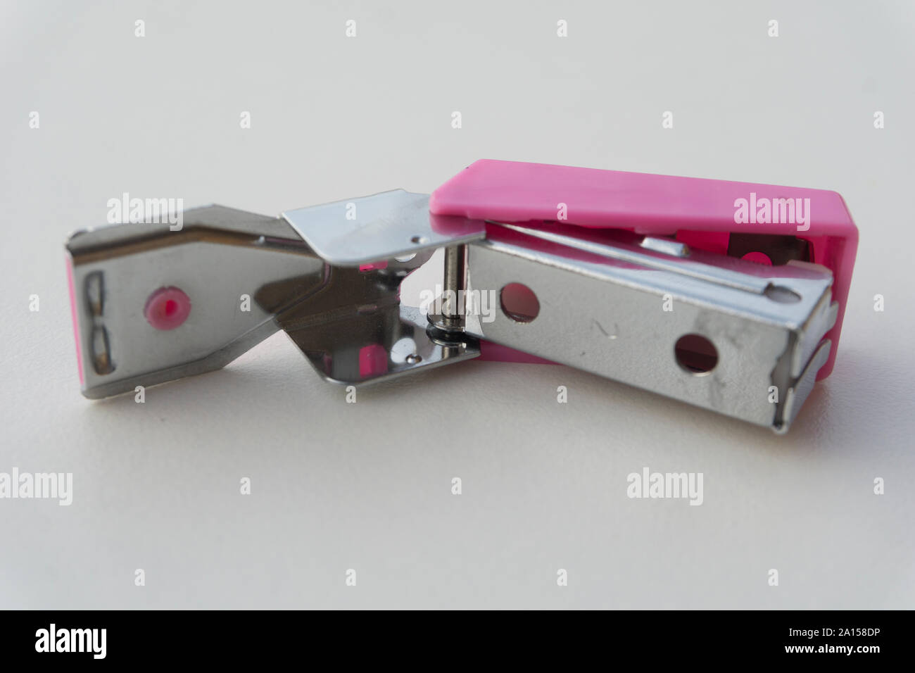 Small pink stapler isolated on white background Stock Photo - Alamy