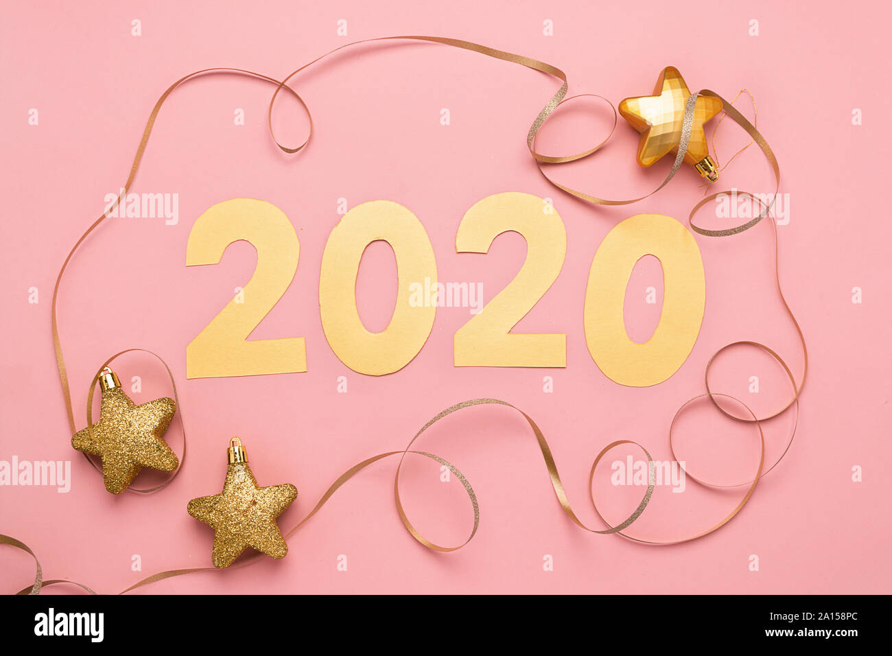 The symbol of the new year, numbers 2020 cut out of gold paper on a ...