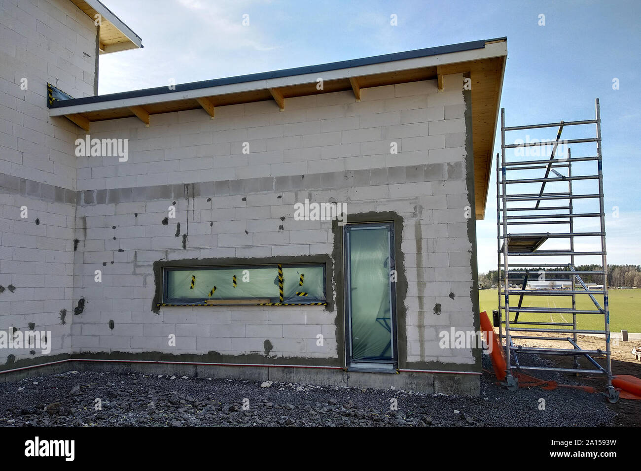 Facade of white block building under construction works Stock Photo - Alamy